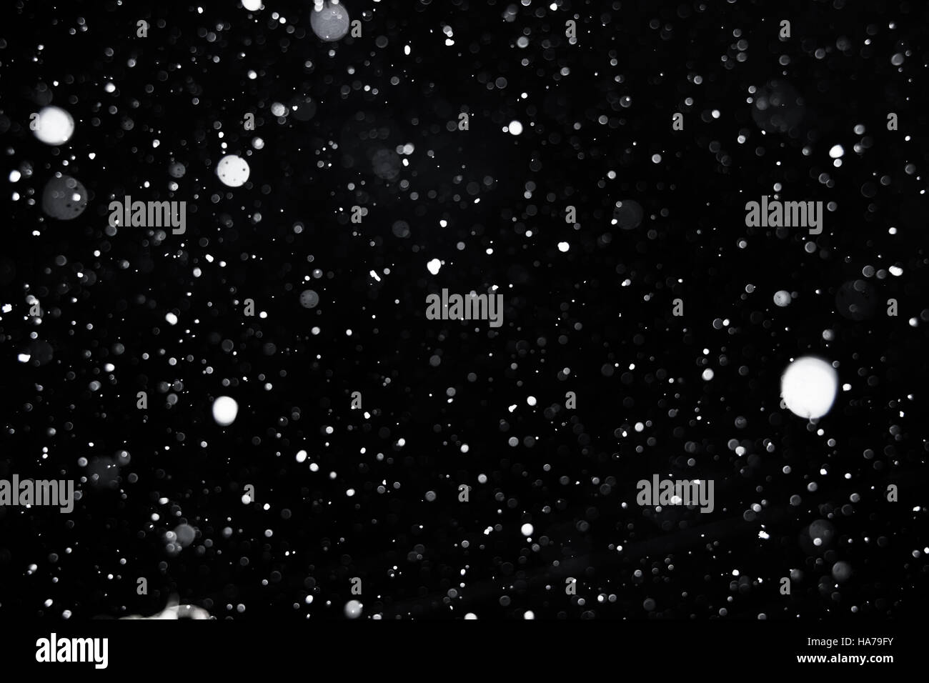 Falling snow on black background Stock Photo - Alamy