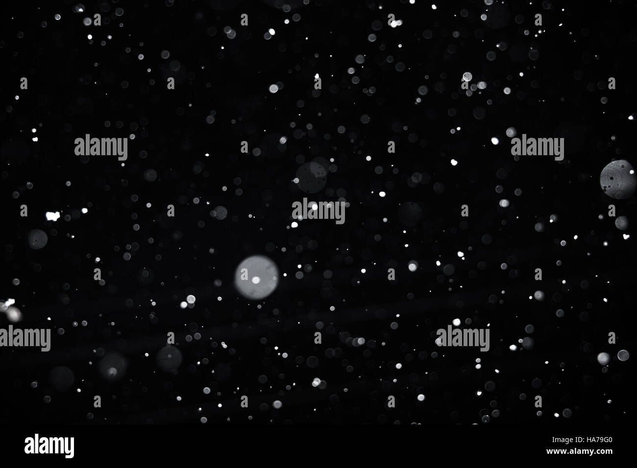 Falling snow on black background Stock Photo - Alamy