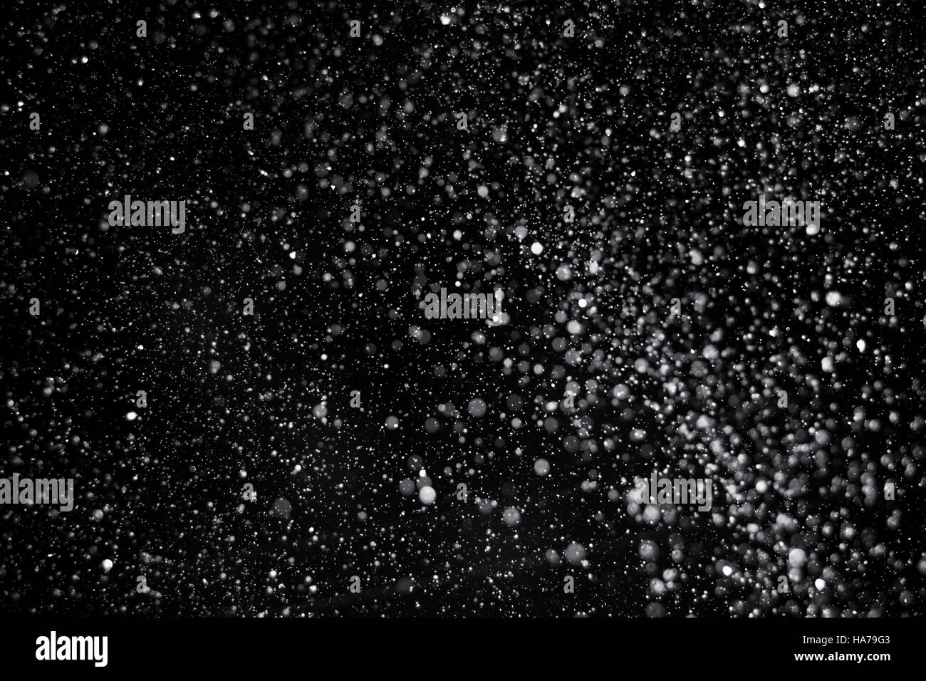 Falling snow on black background Stock Photo - Alamy