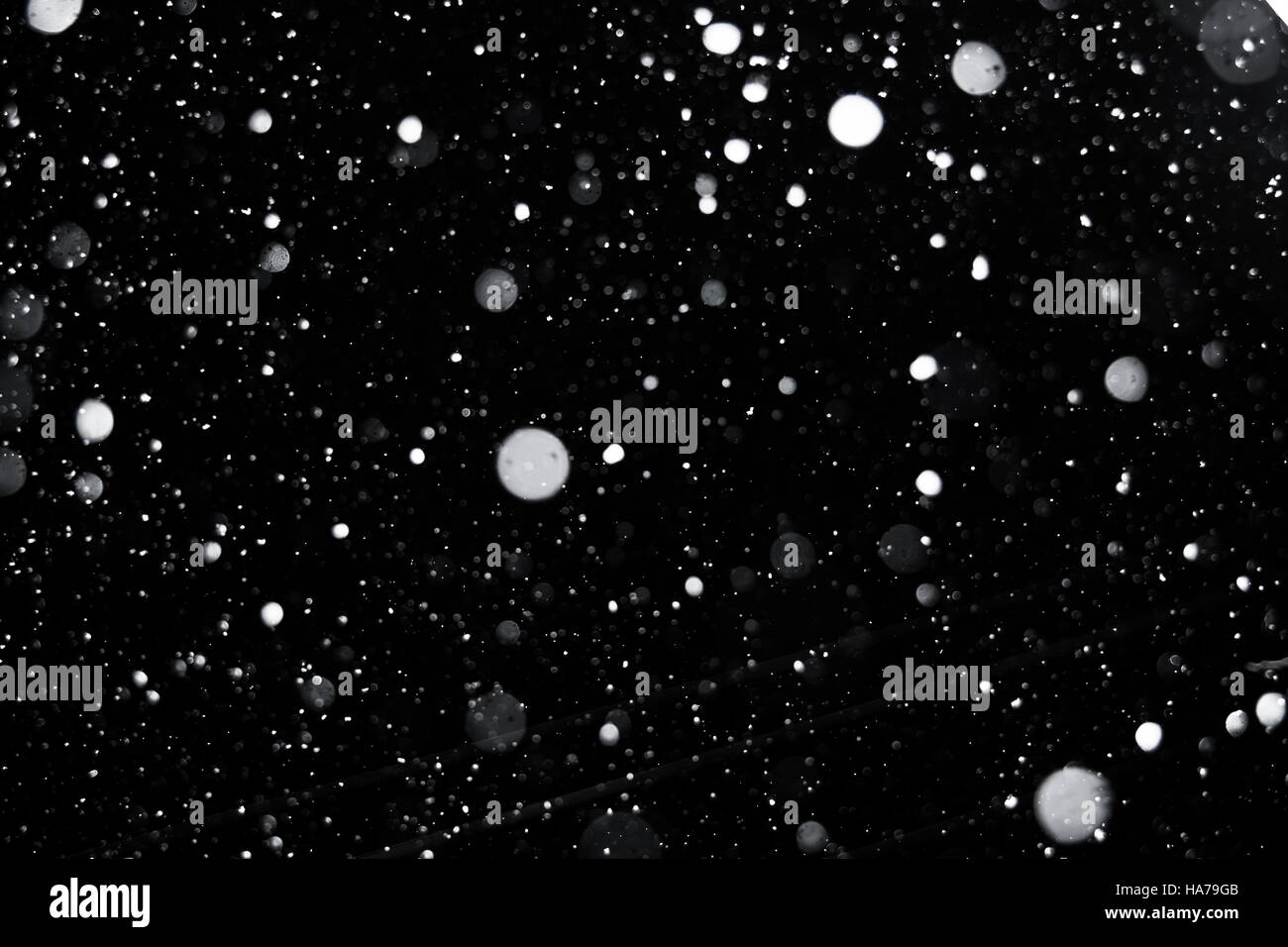 Falling snow on black background Stock Photo - Alamy