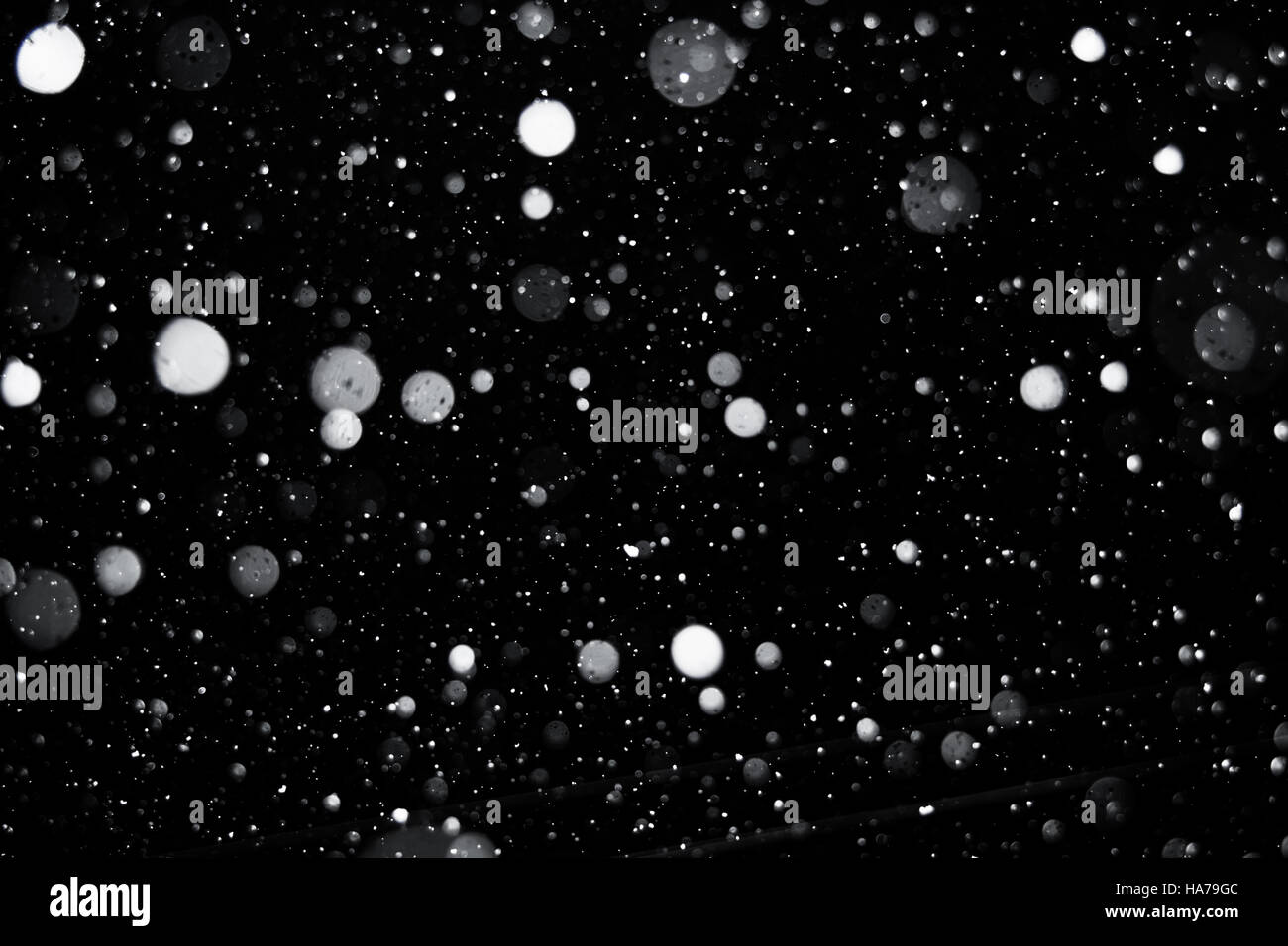 Falling snow on black background Stock Photo - Alamy