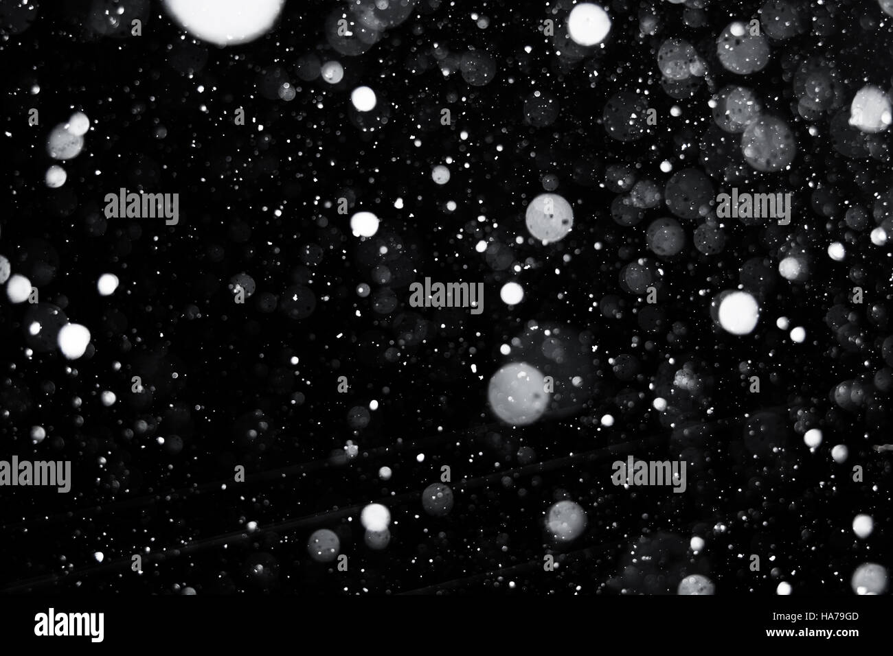 Falling snow on black background Stock Photo - Alamy