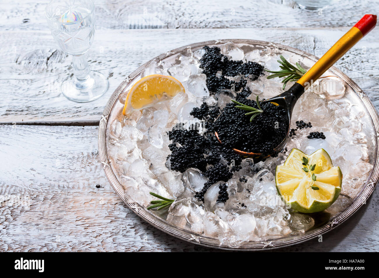 Black caviar in spoon on ice close up. Top view Stock Photo - Alamy