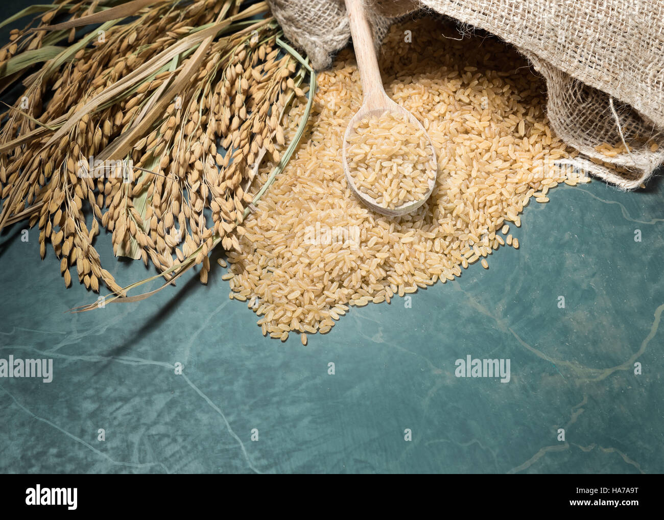 Brown rice uncooked in a bag with a pile of brown rice with over a full ...