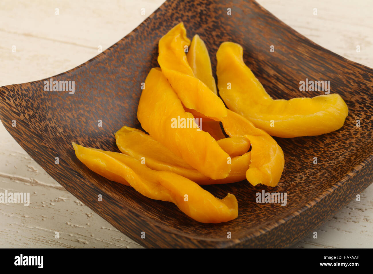 Dry mango chips heap in the bowl Stock Photo - Alamy
