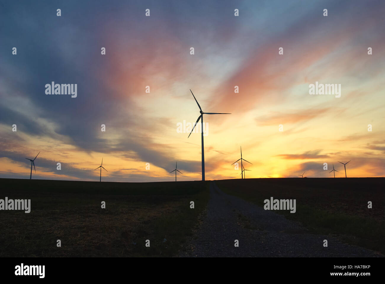 windmill called wind farm power turbine at the sunset with dramatic sky ...