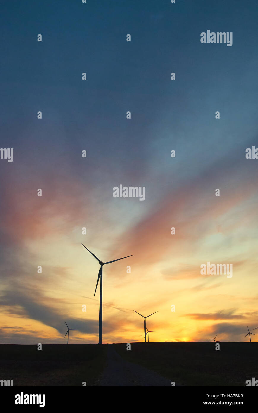 windmill called wind farm power turbine at the sunset with dramatic sky ...