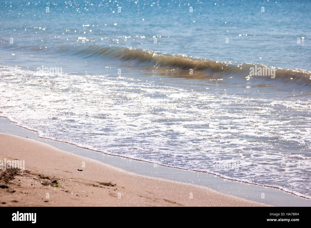 Small wave on the shore Stock Photo - Alamy