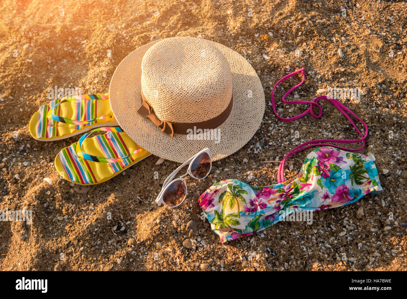 Sunglasses and hat on sand Stock Photo - Alamy