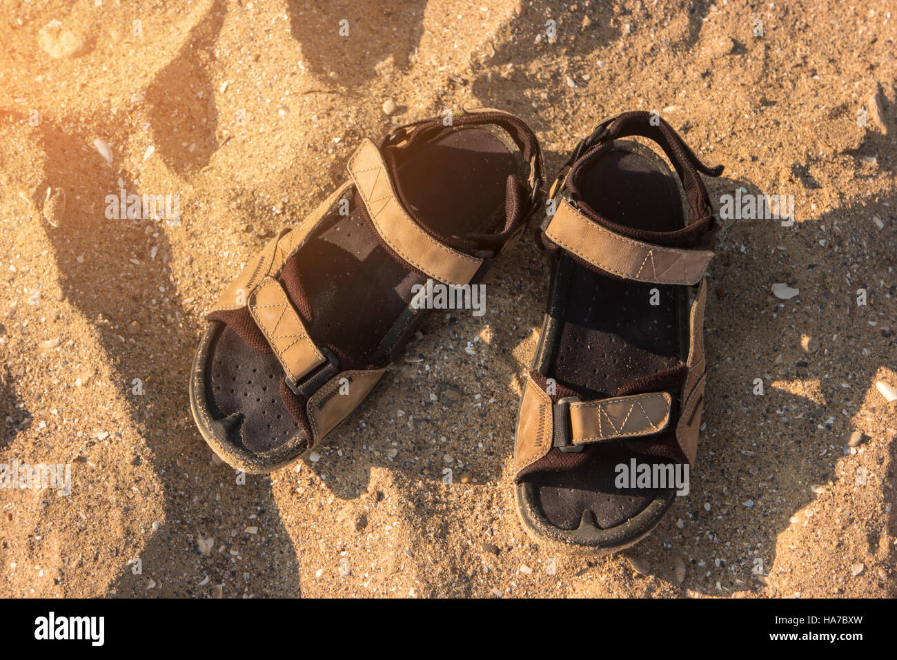 Sandals on sand Stock Photo - Alamy