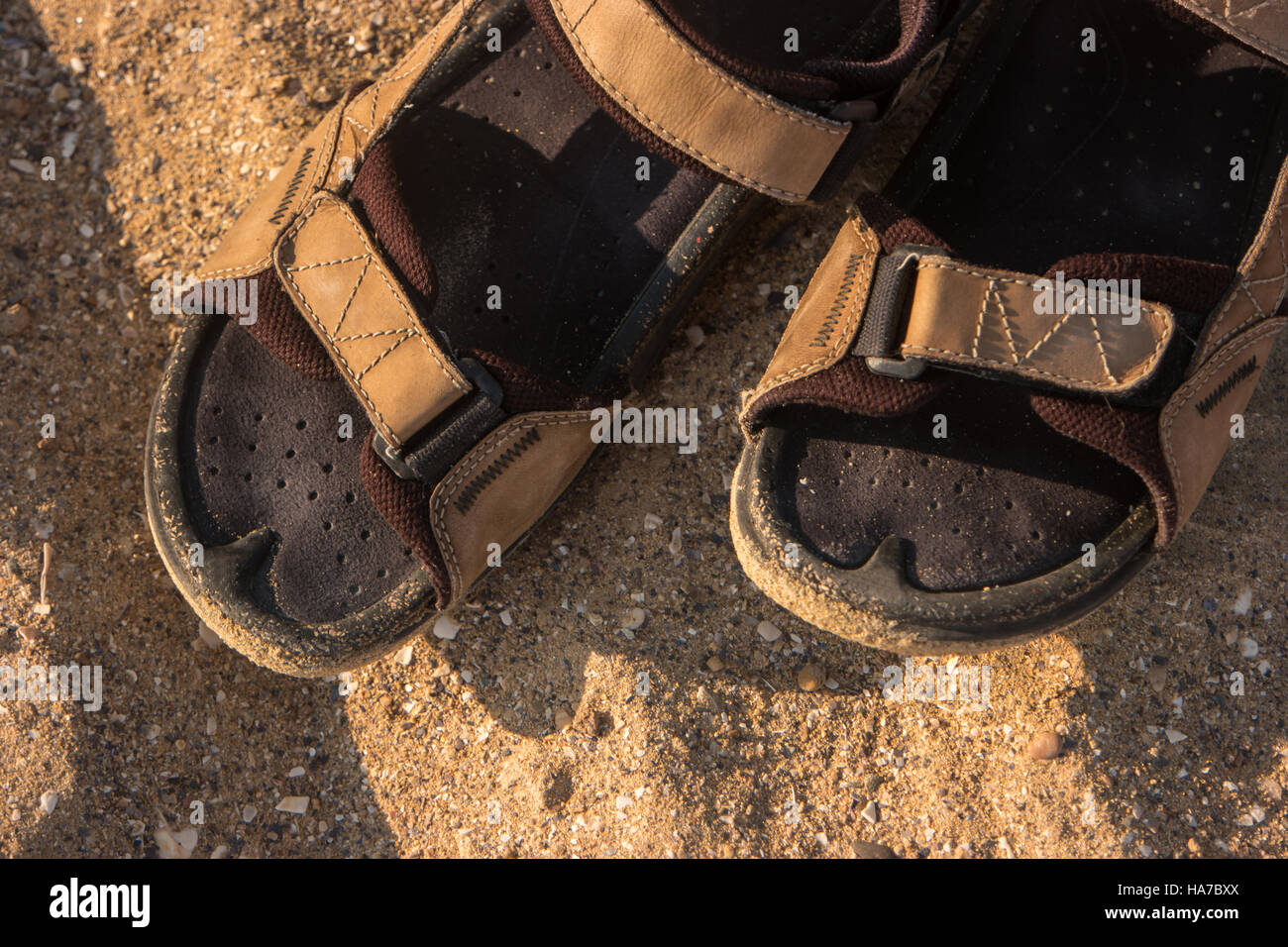 Pair of sandals on sand Stock Photo - Alamy
