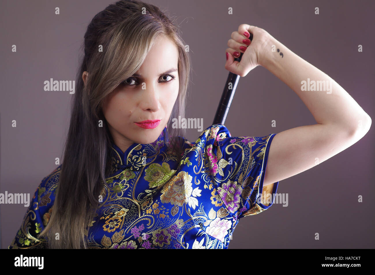 Samurai woman dressed in traditional colorful flower pattern asian silk ...