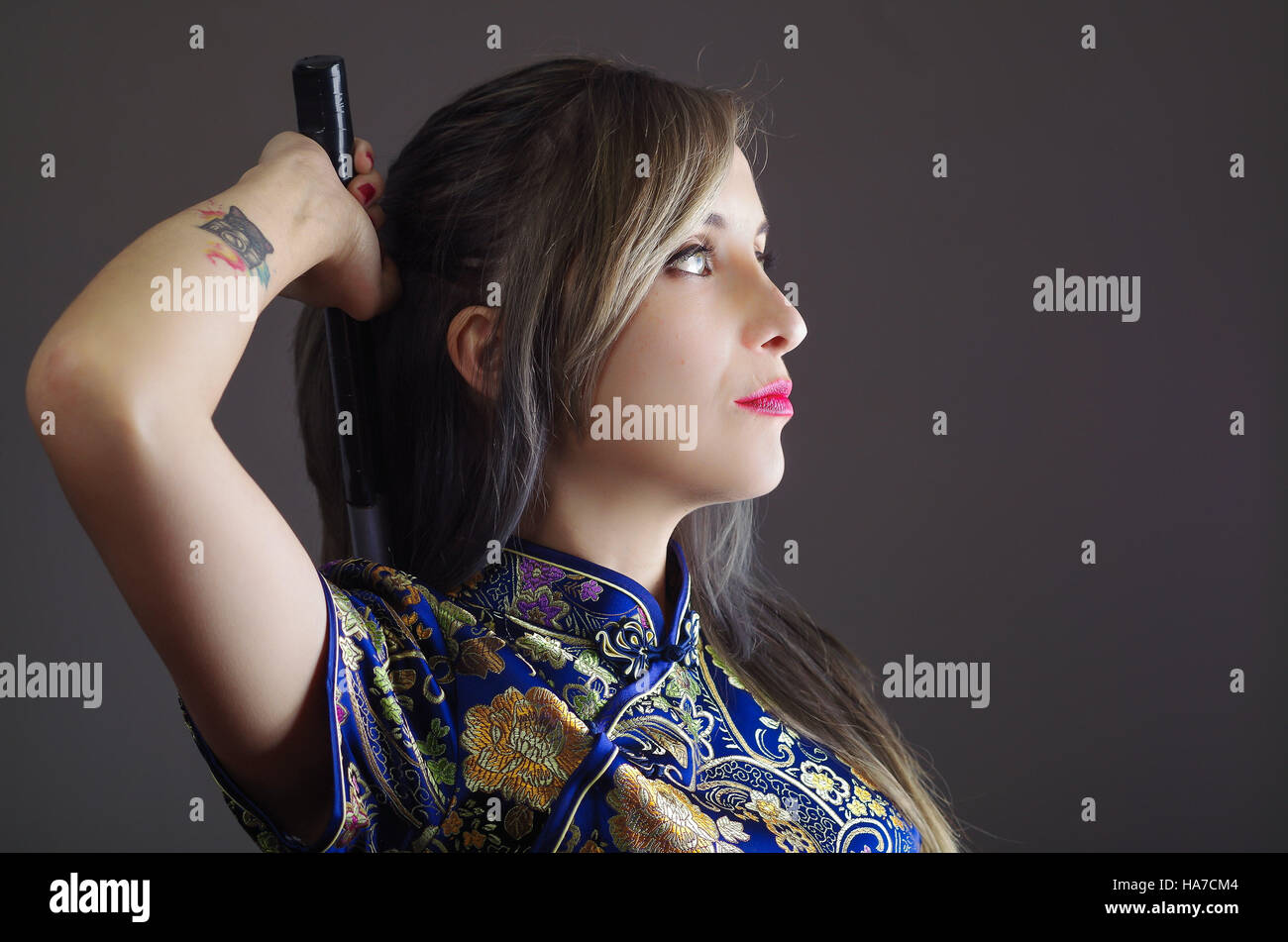 Samurai woman dressed in traditional colorful flower pattern asian silk ...