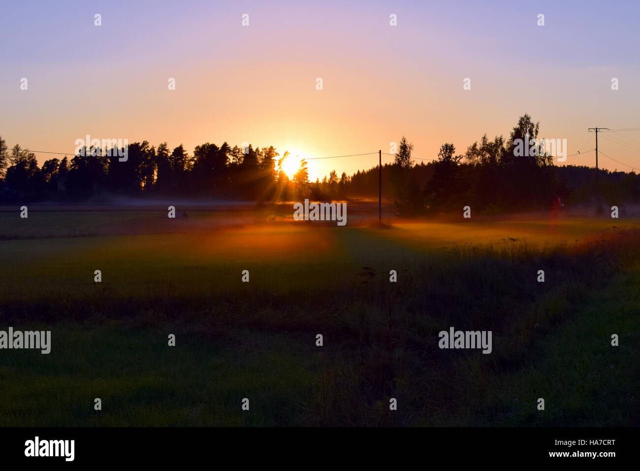 Sunset on Finnish countryside Stock Photo - Alamy