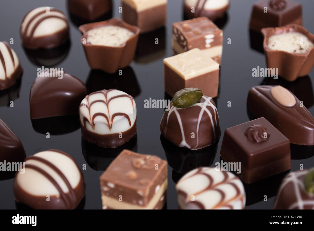 An assortment of fine chocolates in white, dark, and milk chocolate ...