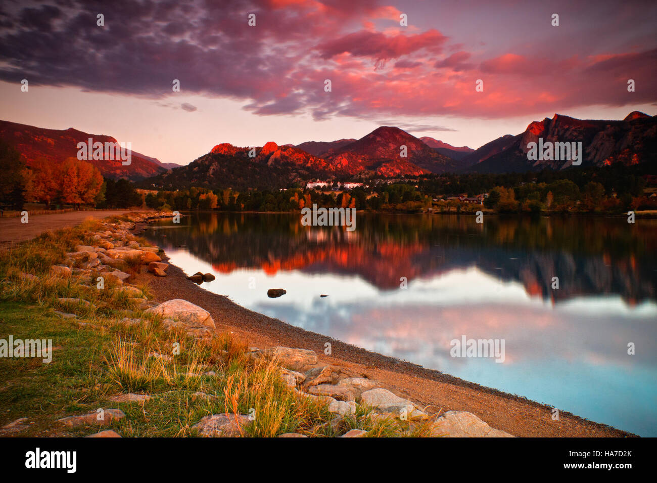 Lake Estes in Estes Park, Colorado reflects the color of the sunrise on ...