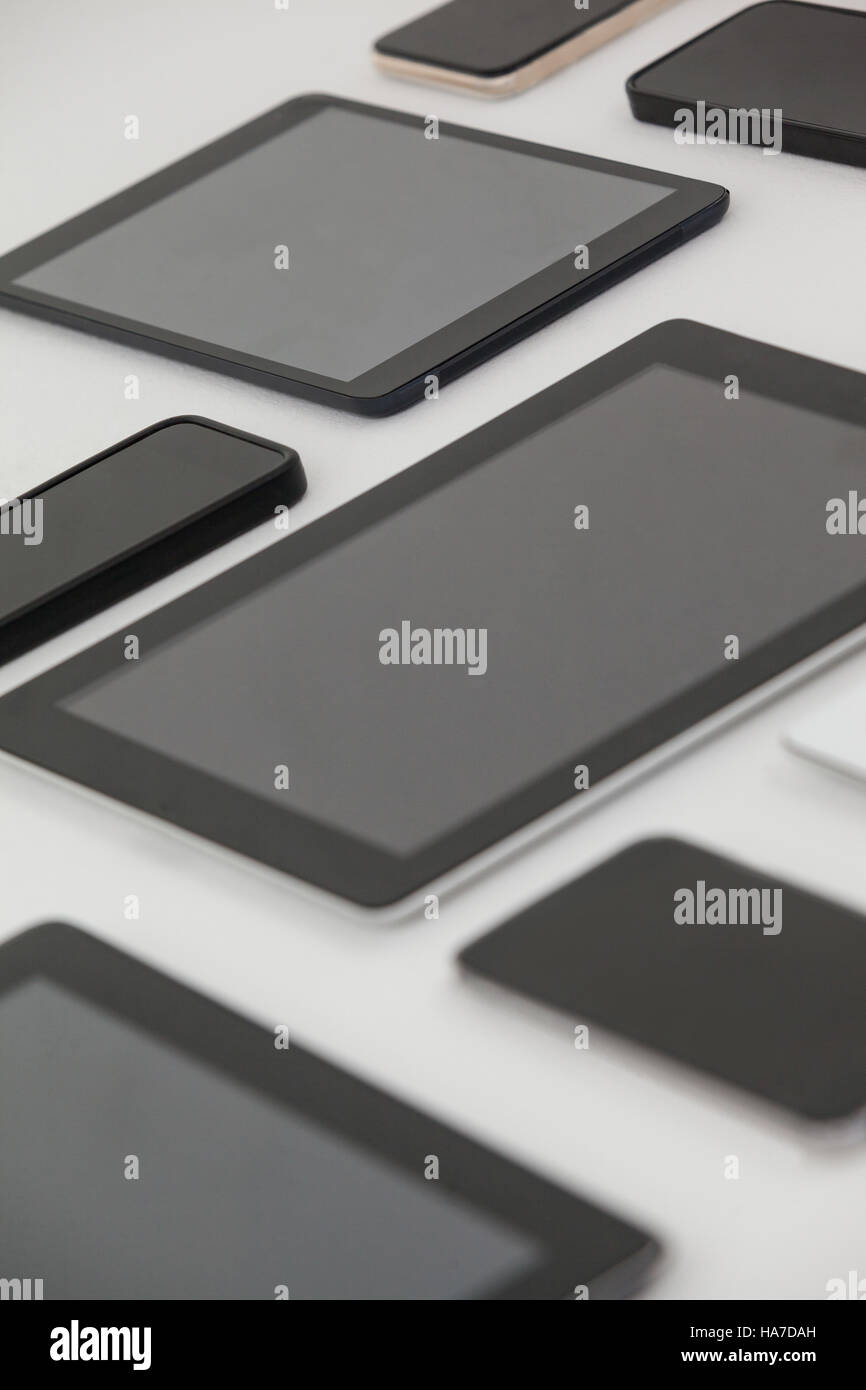 Mobile phones and digital tablets on table Stock Photo - Alamy