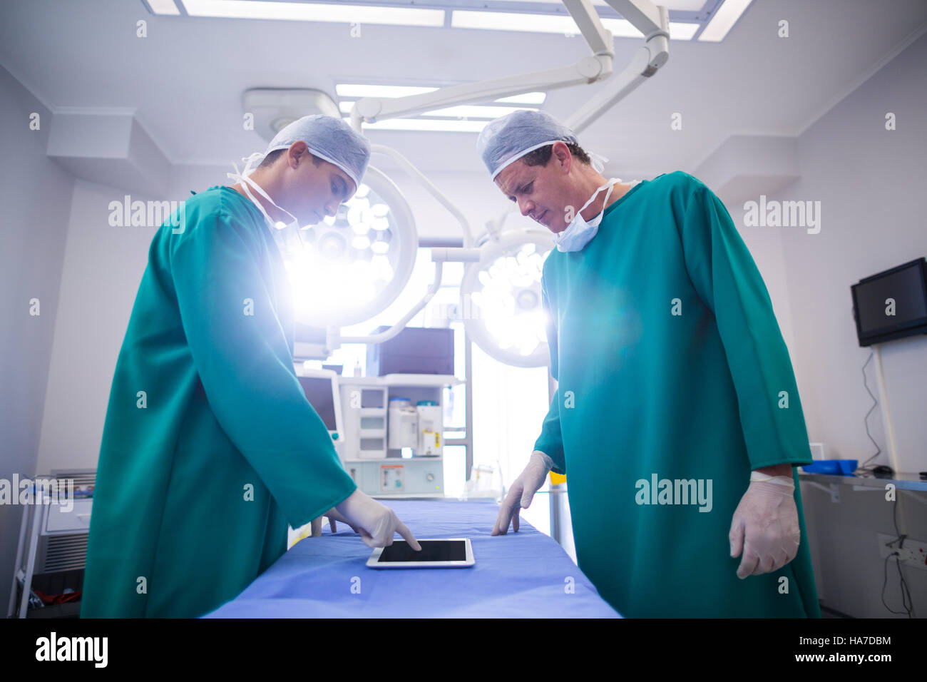 Surgeons using digital tablet in operation theater Stock Photo - Alamy