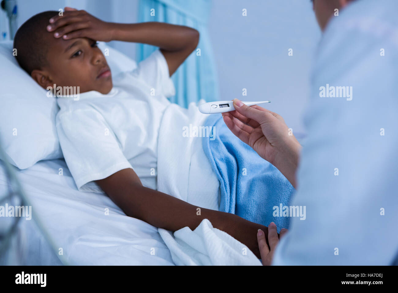 Doctor checking patient fever during visit in ward Stock Photo - Alamy