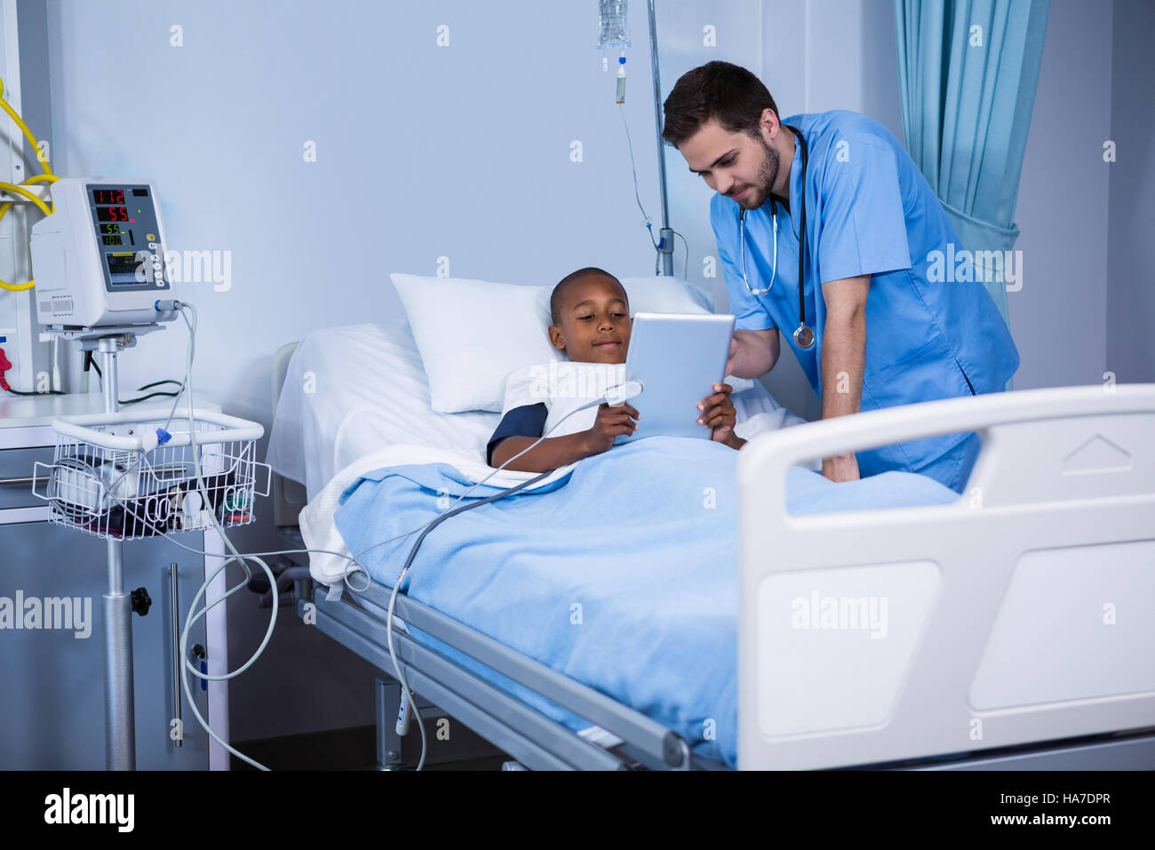 Male nurse and patient using digital tablet in ward Stock Photo - Alamy