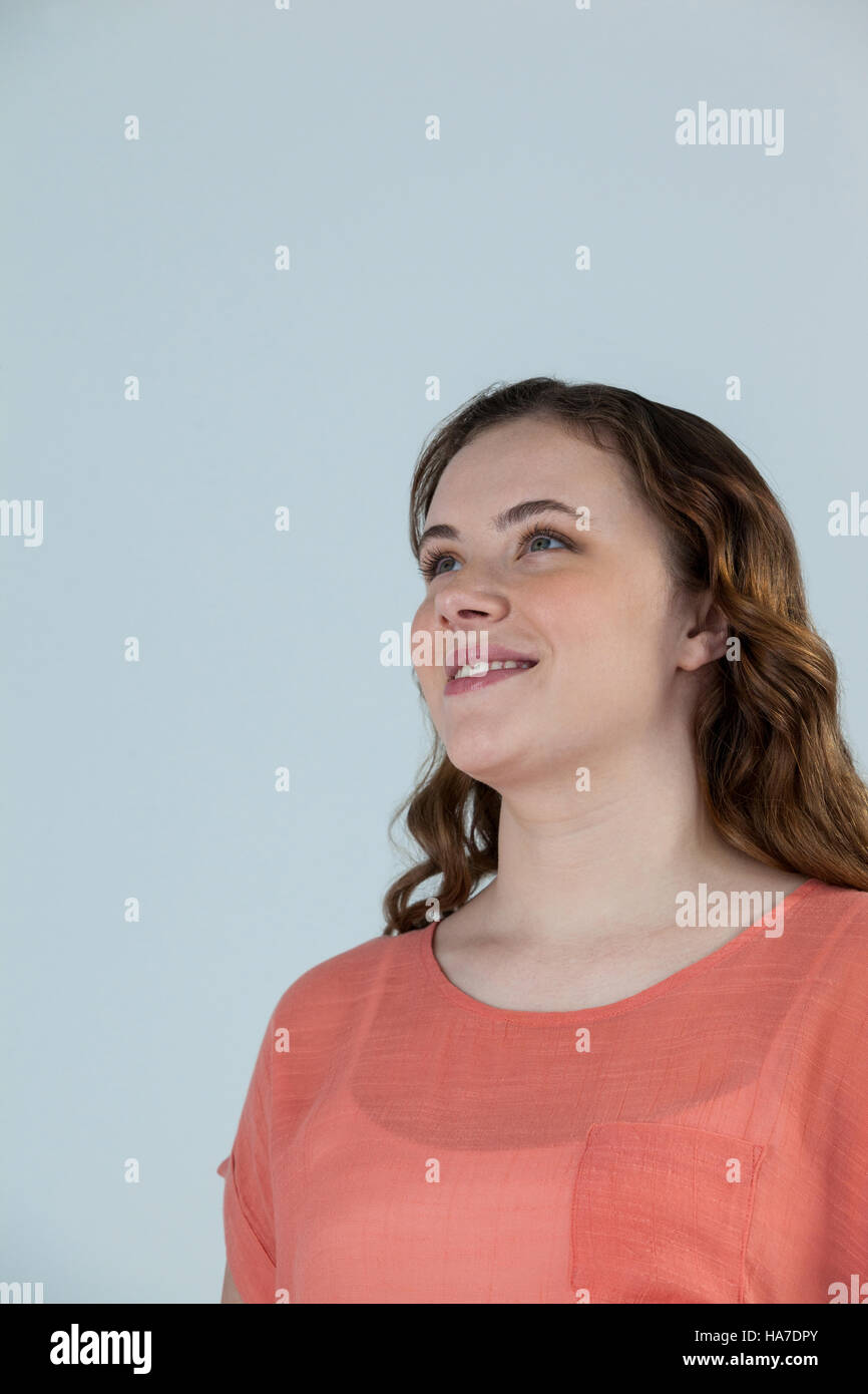 Smiling woman looking upward Stock Photo - Alamy