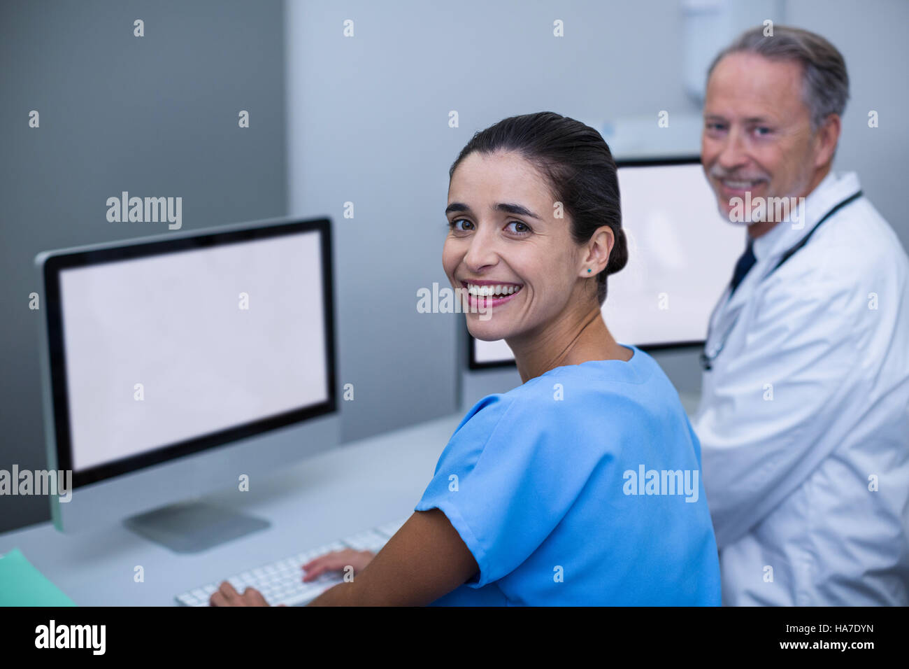 Doctor and nurse working on computer Stock Photo - Alamy
