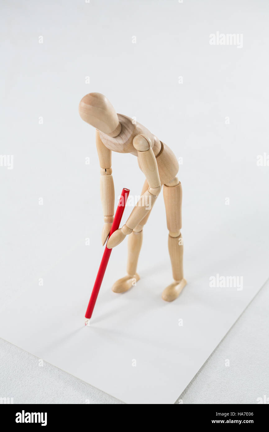 Wooden figurine drawing on a paper Stock Photo - Alamy