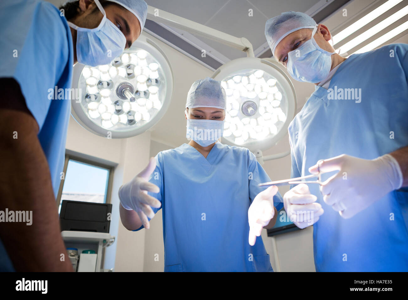 Surgeons performing operation in operation room Stock Photo - Alamy
