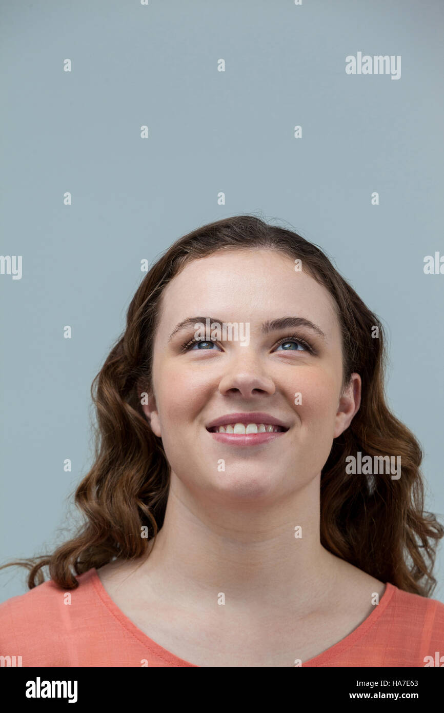 Smiling woman looking upward Stock Photo - Alamy