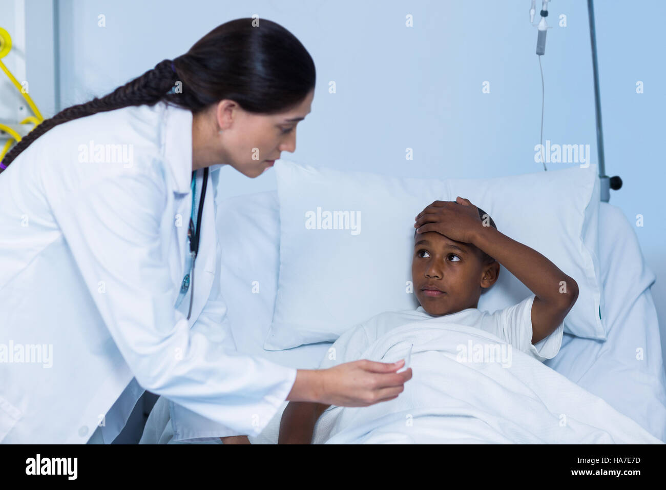 Female doctor checking fever from digital thermometer Stock Photo - Alamy