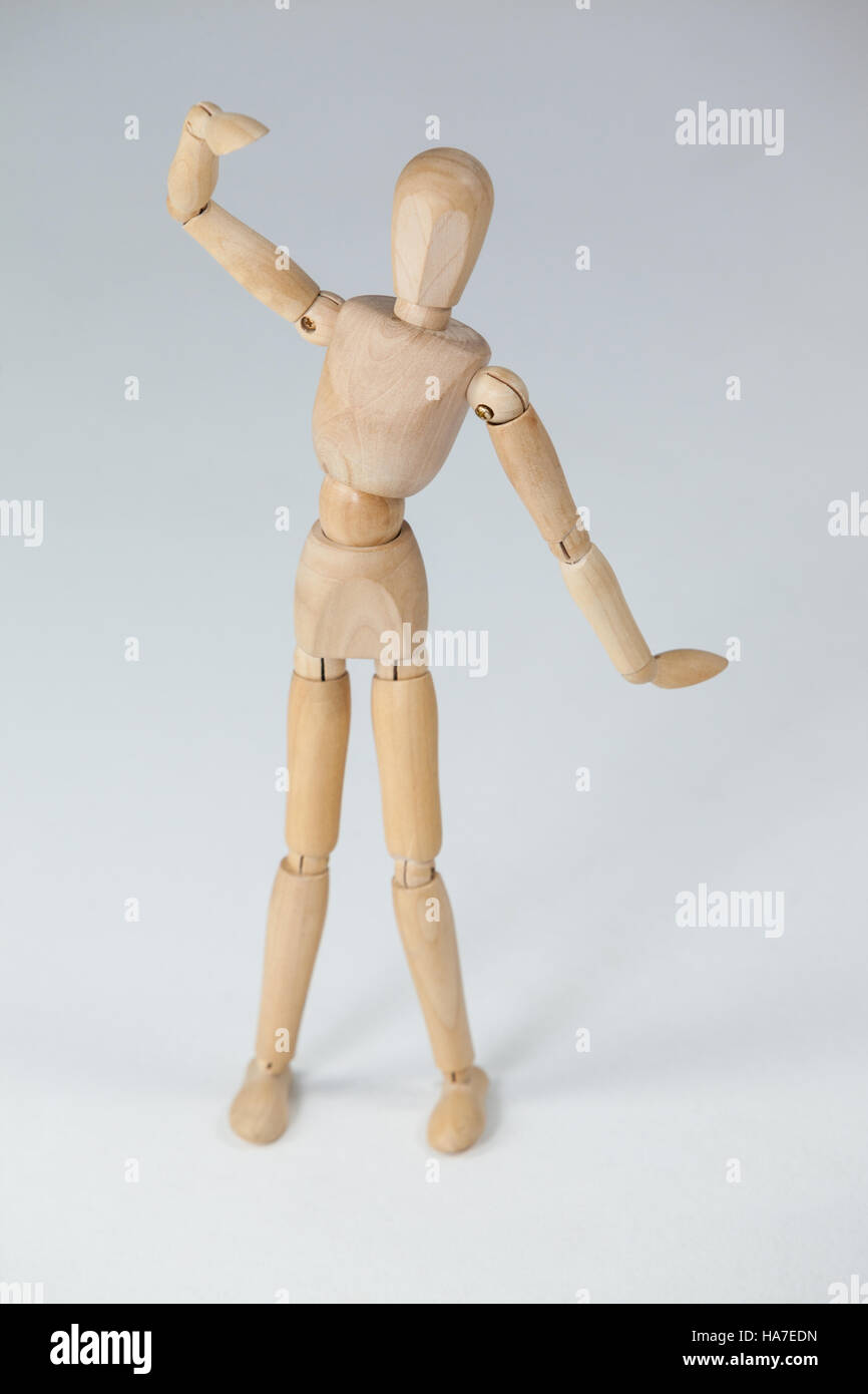 Wooden figurine standing with hand raised Stock Photo - Alamy