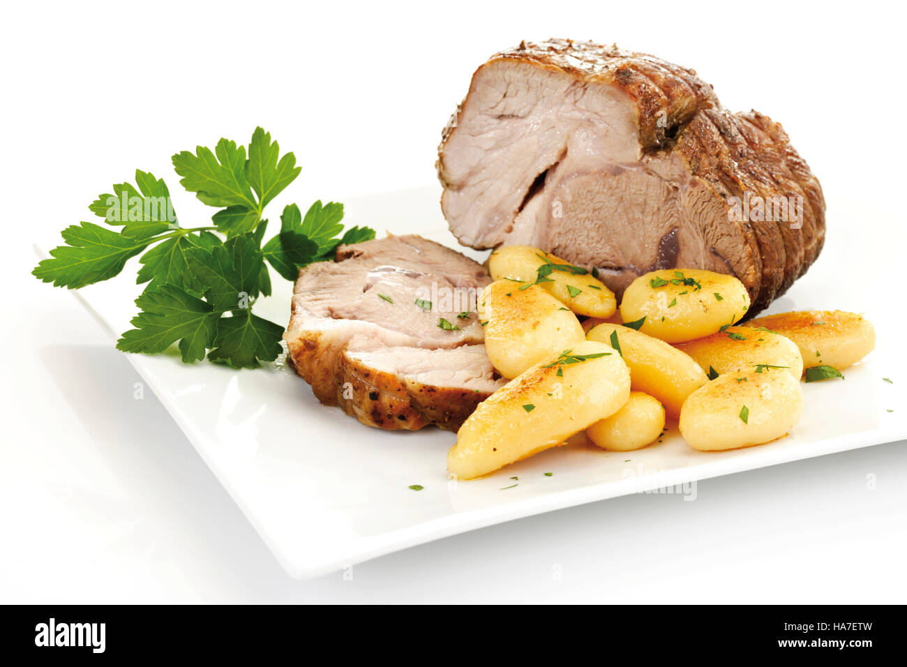 Rolled roasted pork, sliced, potatoes Stock Photo - Alamy