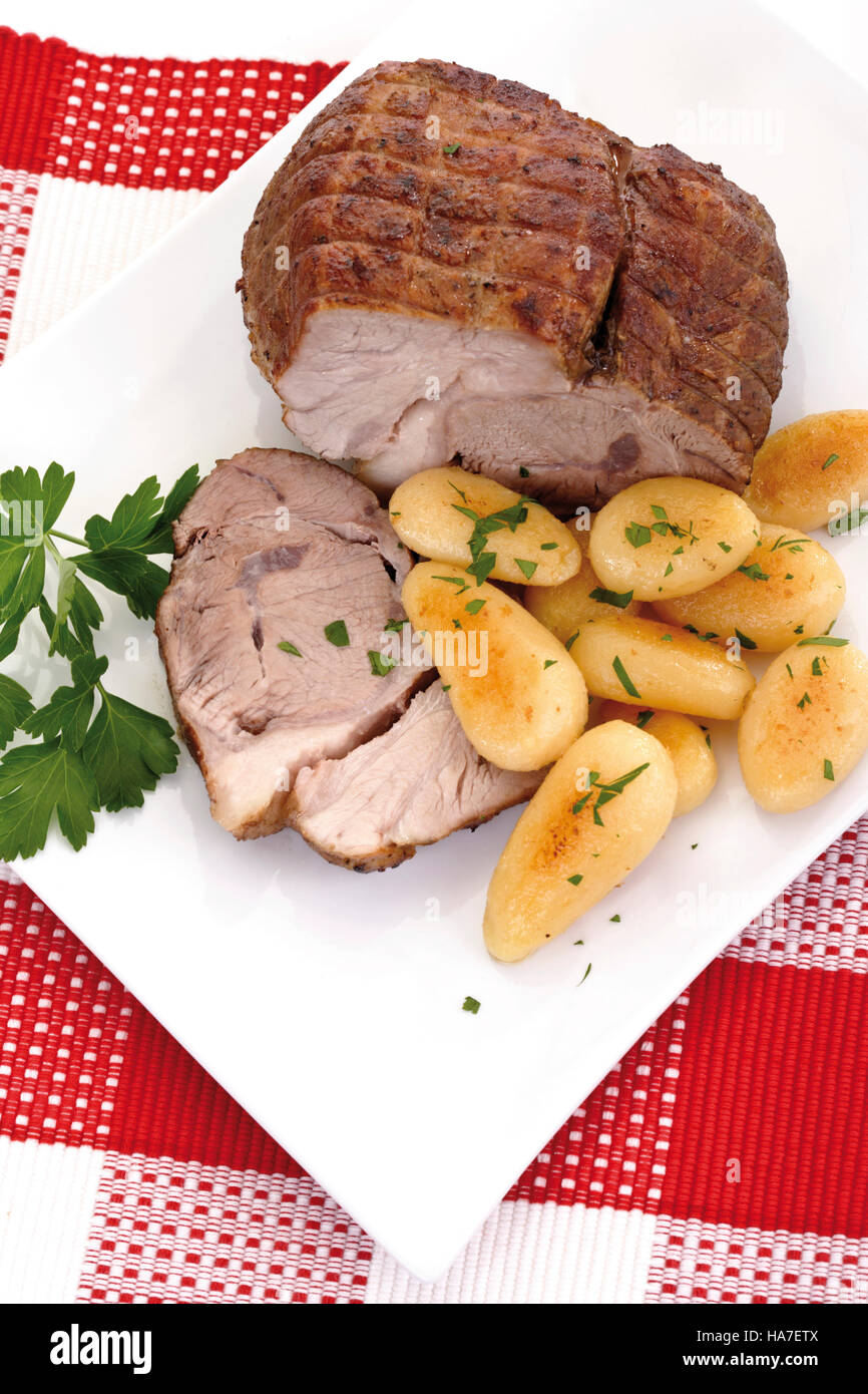 Rolled roasted pork, sliced, potatoes Stock Photo - Alamy
