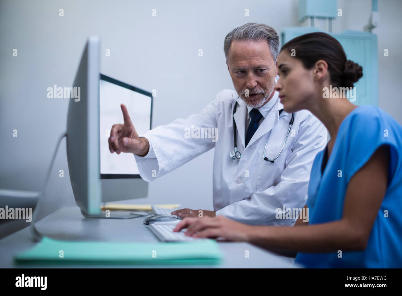 Doctor and nurse working on computer Stock Photo - Alamy