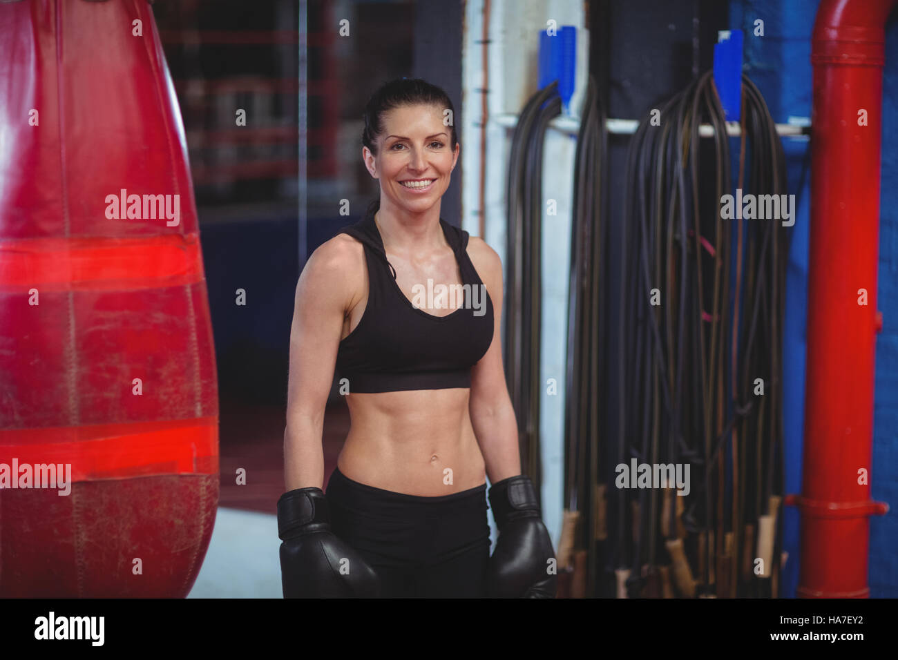 Smiling female boxer with boxing gloves Stock Photo - Alamy