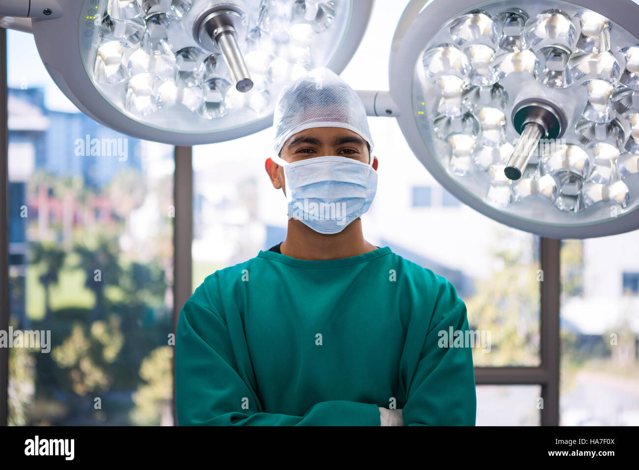 Portrait of surgeon standing with arms crossed in operation room Stock ...