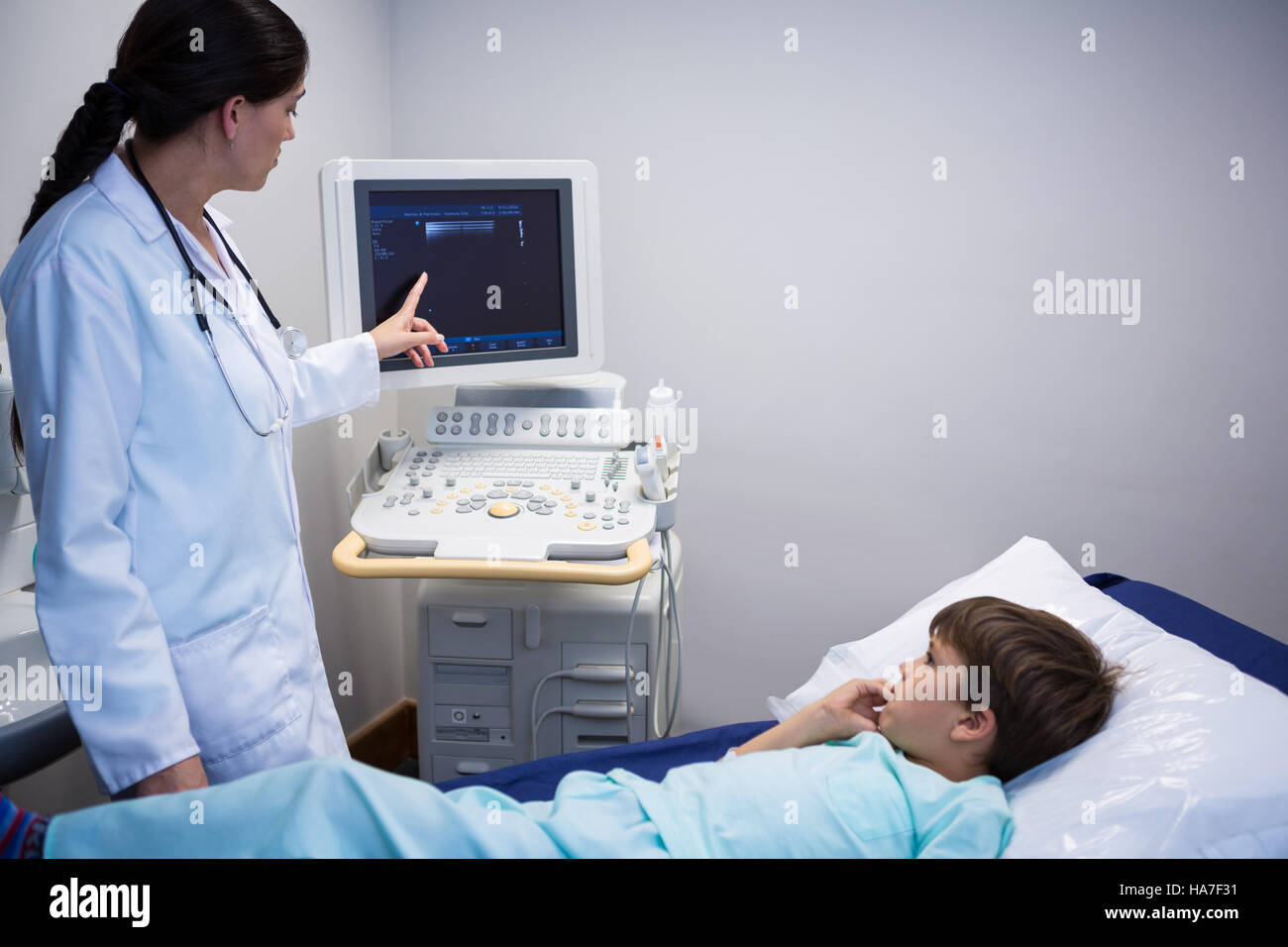 Female doctor explaining sonography report to patient on screen Stock ...