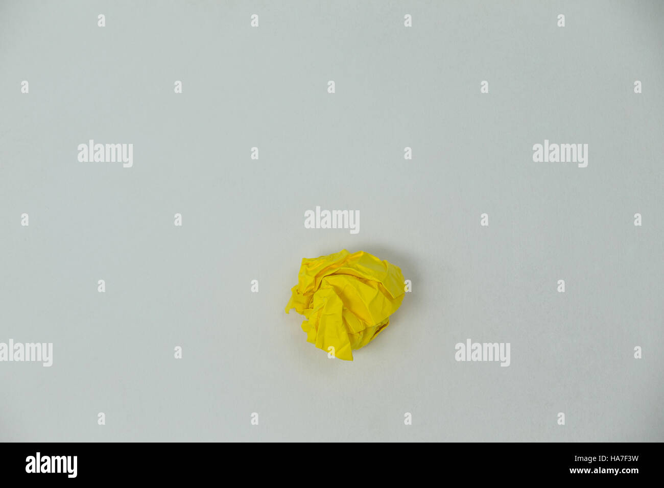Yellow crumpled paper ball on a white background Stock Photo - Alamy