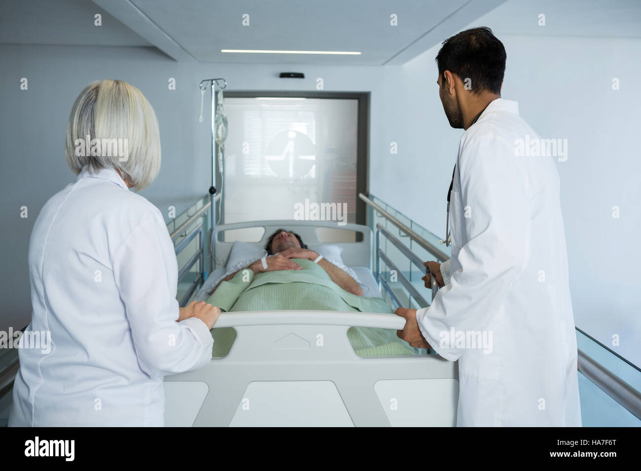 Doctor pushing emergency stretcher bed in corridor Stock Photo - Alamy