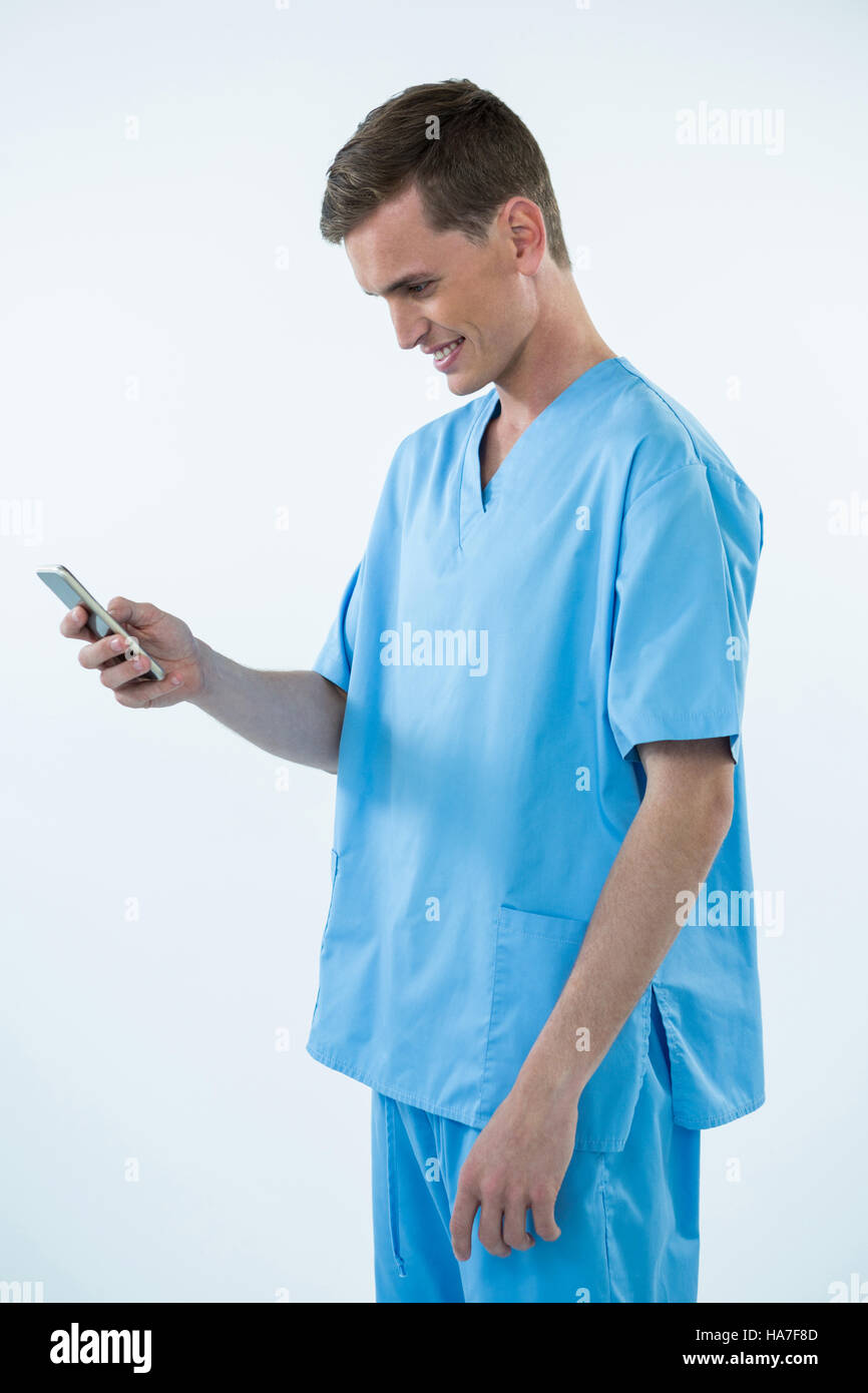 Smiling male nurse using mobile phone Stock Photo - Alamy