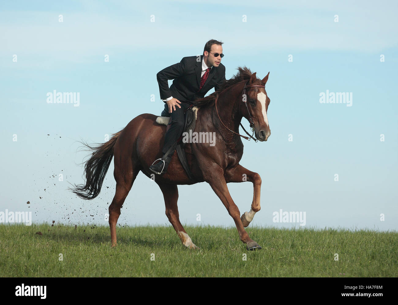Businessman, manager riding a horse Stock Photo - Alamy