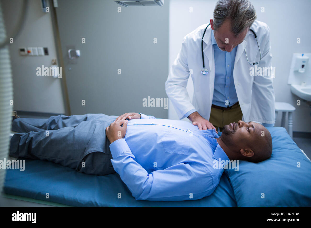 Doctor consoling a patient on bed Stock Photo - Alamy