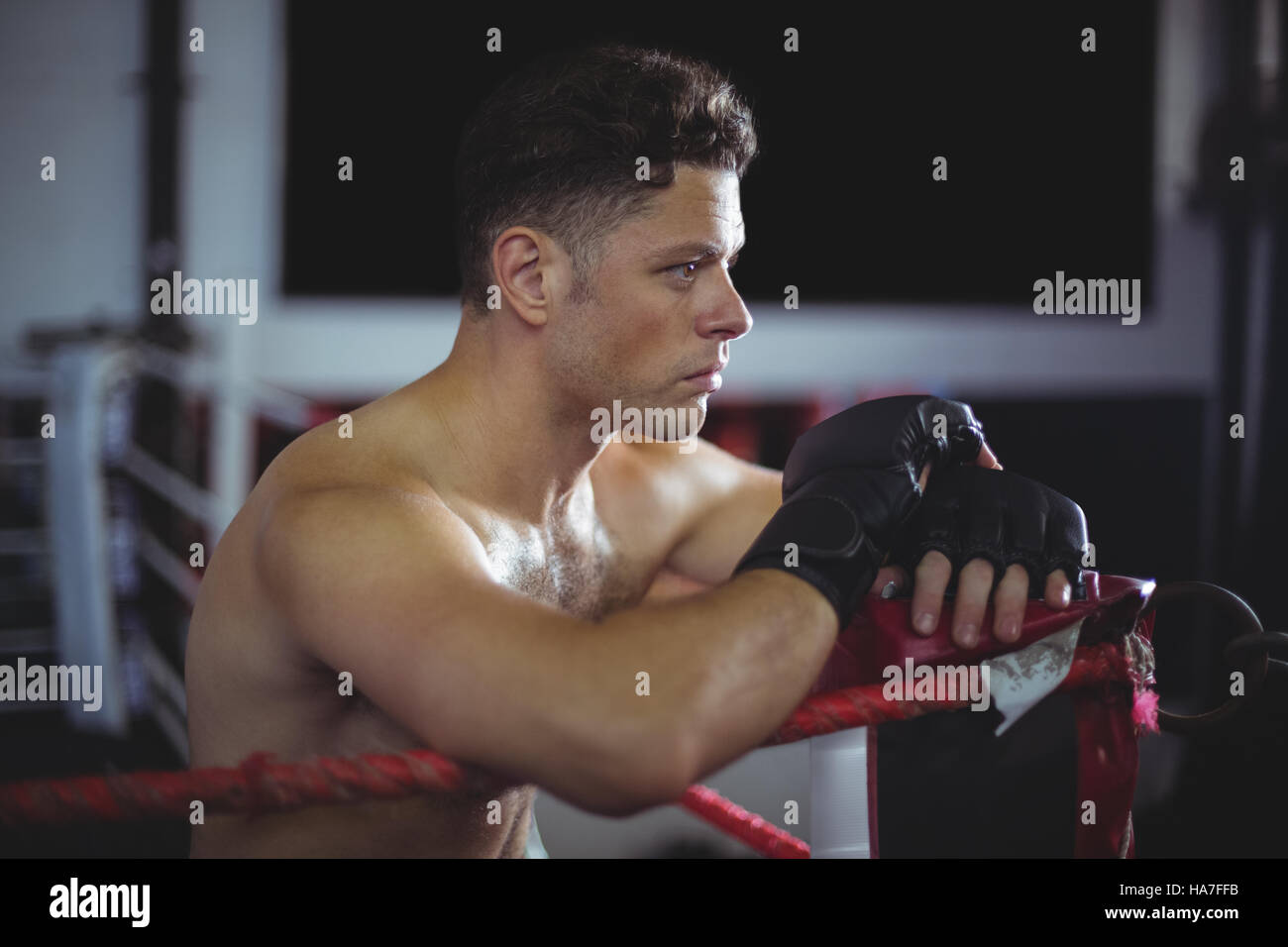 Boxer leaning on boxing ring Stock Photo - Alamy