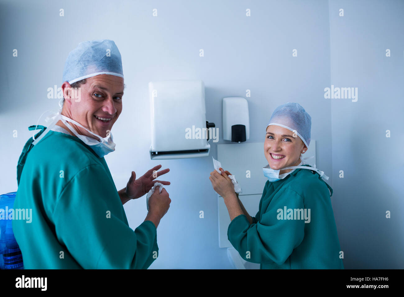 Portrait of happy surgeons cleaning their hands after operation Stock ...