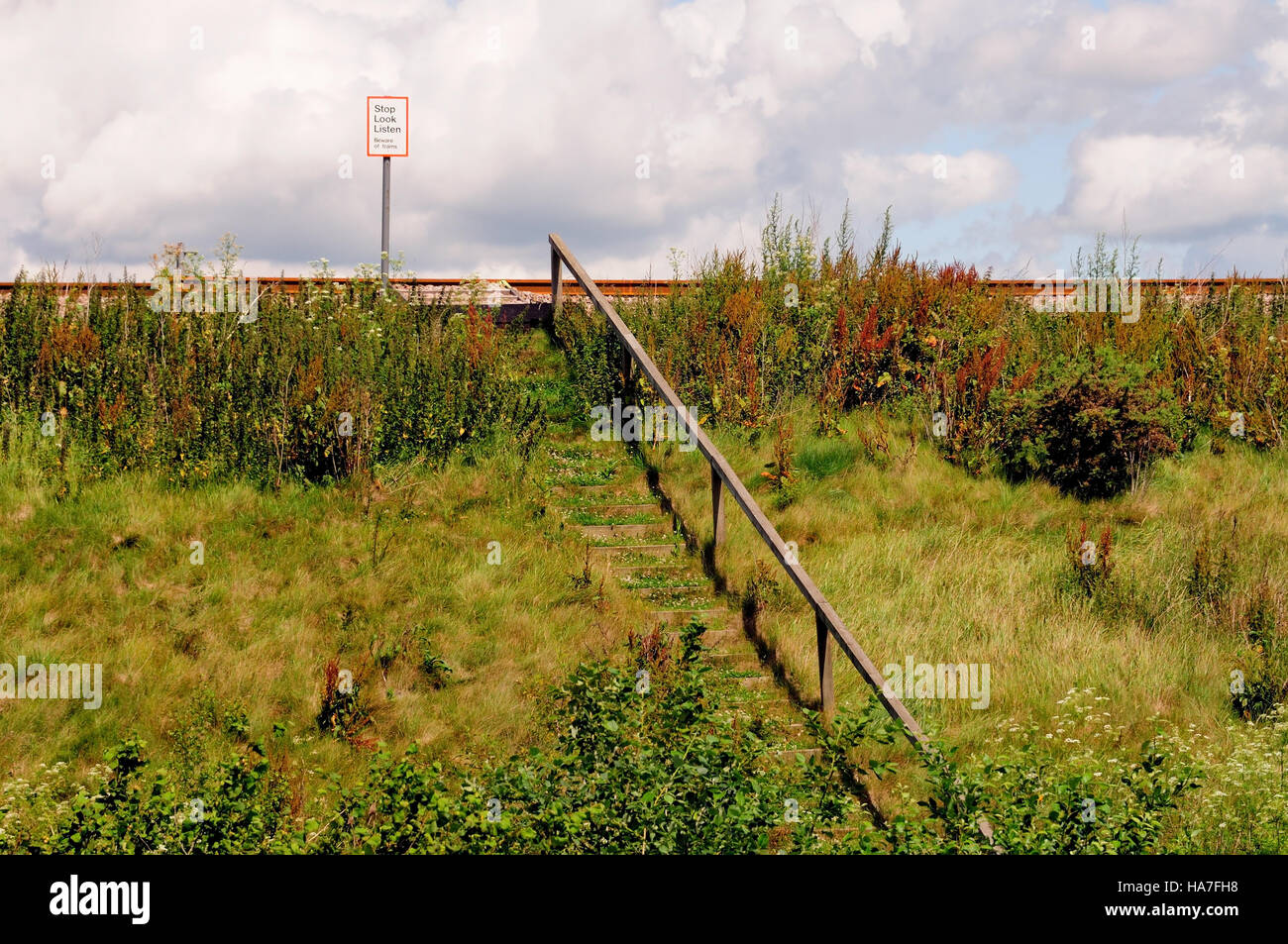 Steps leading up to a footpath crossing over a main line railway Stock ...