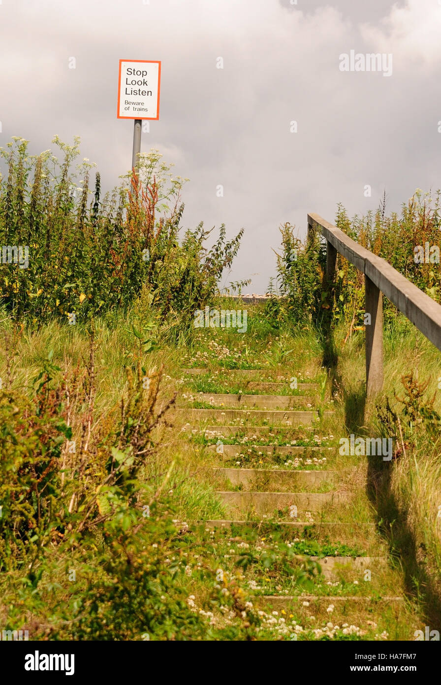 Steps leading up to a footpath crossing over a main line railway Stock ...