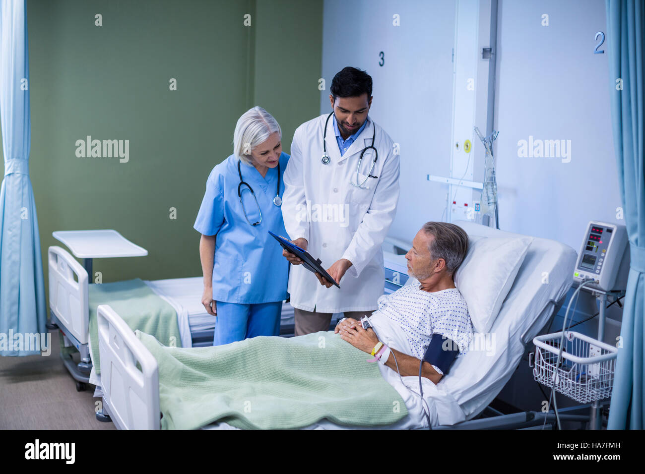 Doctor and nurse examining a patient Stock Photo - Alamy