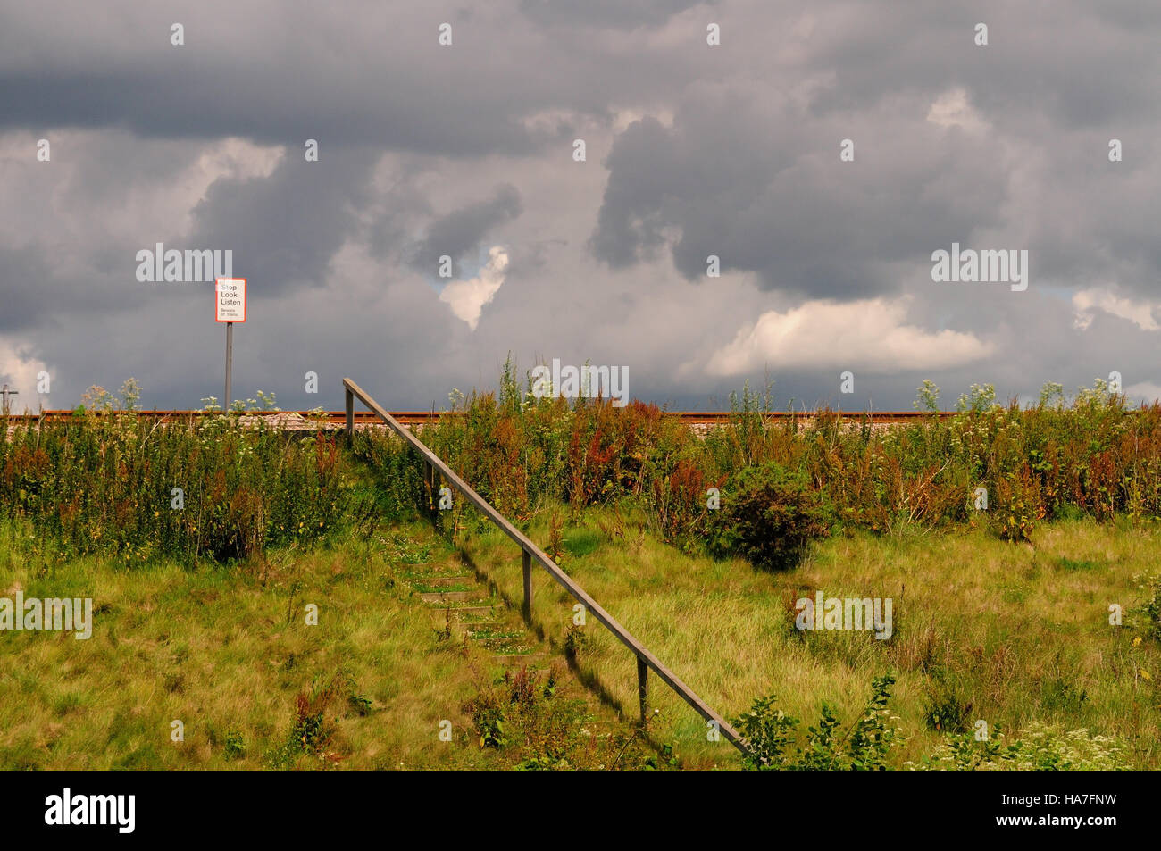 Steps leading up to a footpath crossing over a main line railway Stock ...