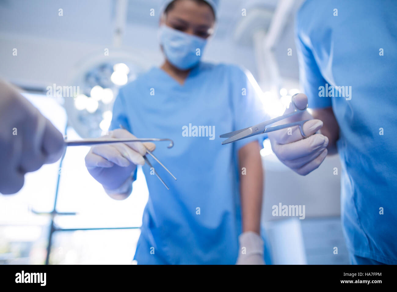 Group of surgeons performing operation in operation room Stock Photo ...