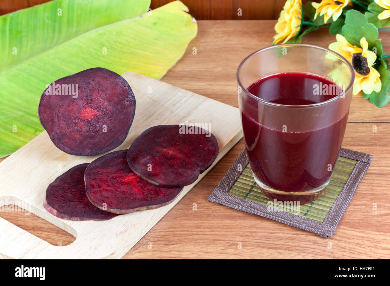 Fresh slices red beetroot and beetroot fruit juice in glass a wood ...